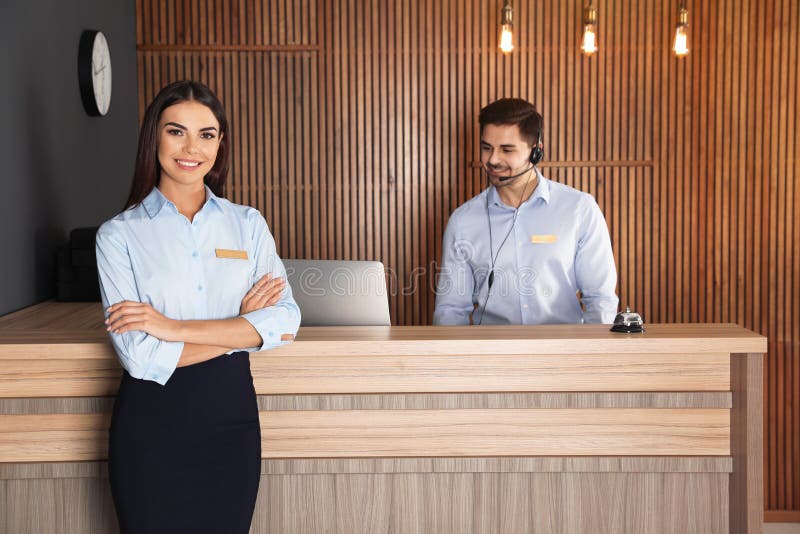 Receptionist at Desk with Colleague Stock Image - Image of happy ...