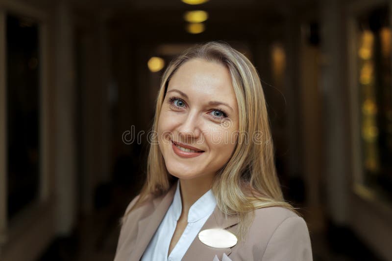Receptionist Greets Visitors with a Smile in the Hallway Stock Photo ...