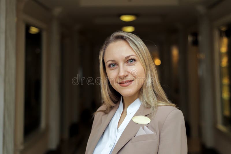 Receptionist Greets Visitors with a Smile in the Hallway Stock Photo ...
