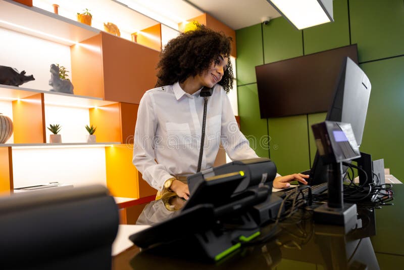 Receptionist Having a Call and Looking Busy Stock Photo - Image of ...