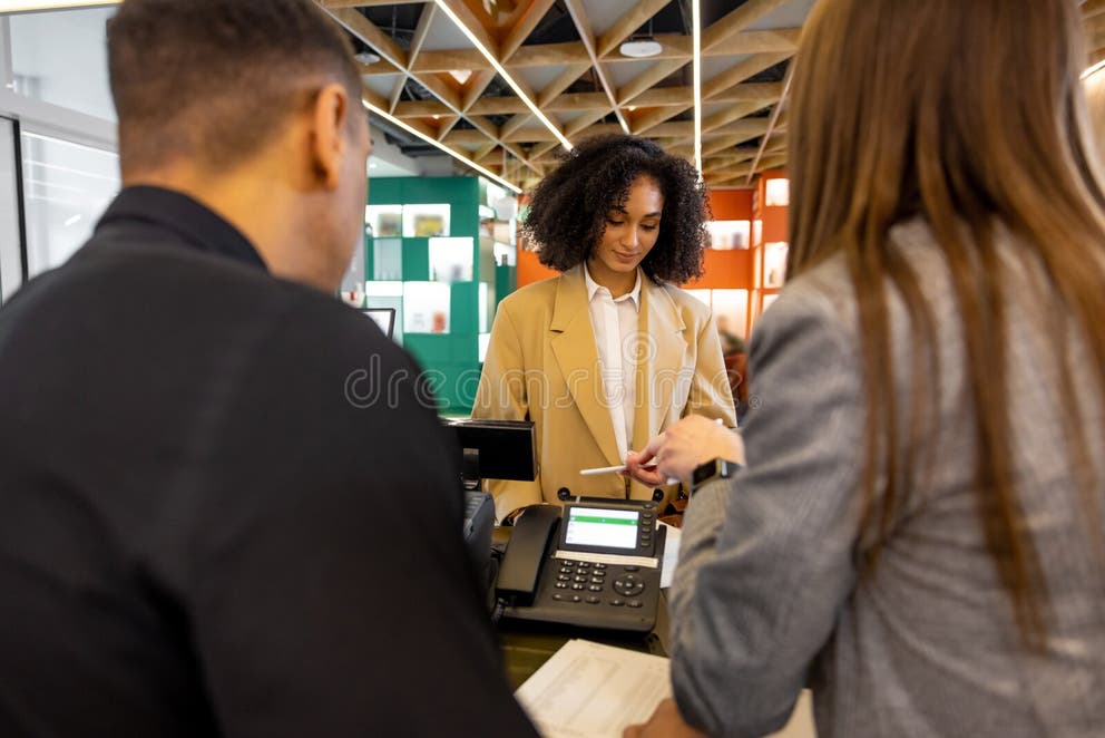 Receptionist Helping a Guest To Check in Stock Image - Image of manager ...