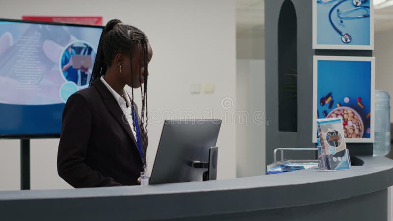 Receptionist Helping Patients with Checkup Forms Stock Footage - Video ...