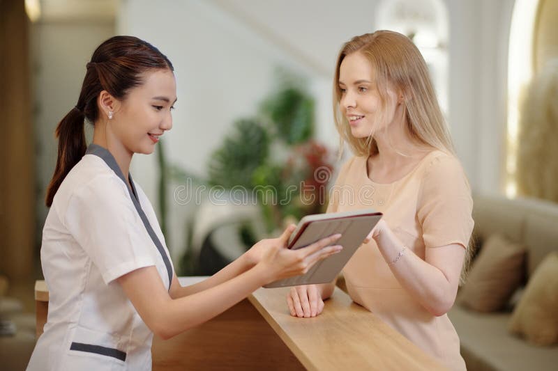 Receptionist Offering Procedure Stock Photo - Image of device, choosing ...