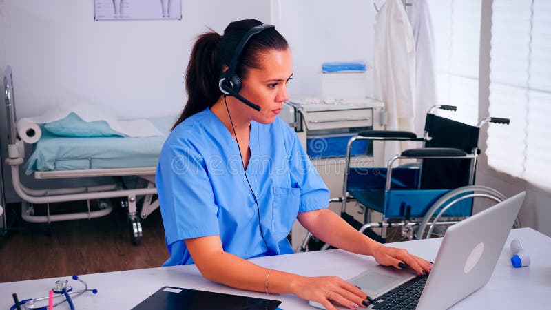 Receptionist, Operator Speaking Online with Patients Using Headphone ...