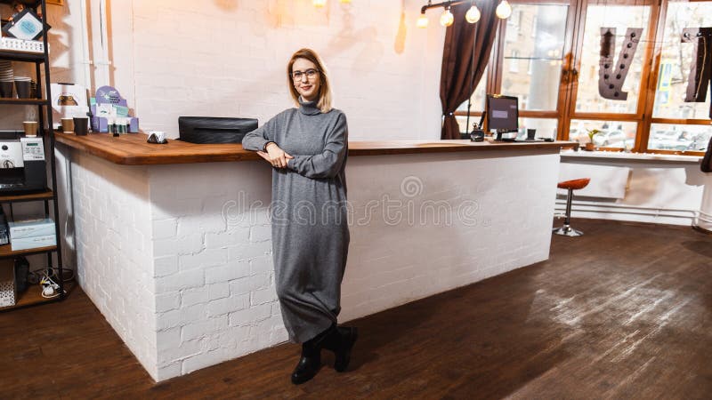 Receptionist Standing at Reception Counter in Office Stock Photo ...