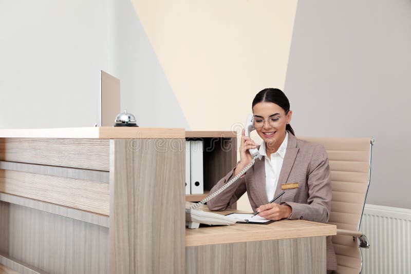 Receptionist Talking on Telephone at Desk Stock Image - Image of adult ...