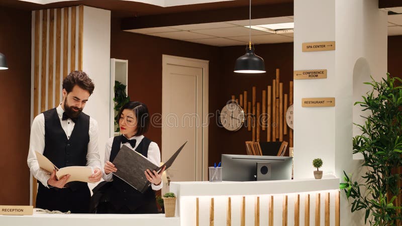 Receptionists Checking Appointments Stock Photo - Image of assisting ...