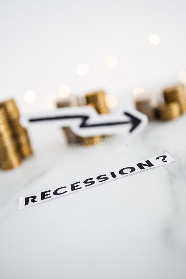 Recession Text with Arrow Going Down in Front of Decreasing Stacks of ...