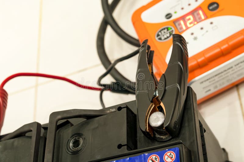 Recharging the Car Battery with Red and Black Copper Clips Attached To ...