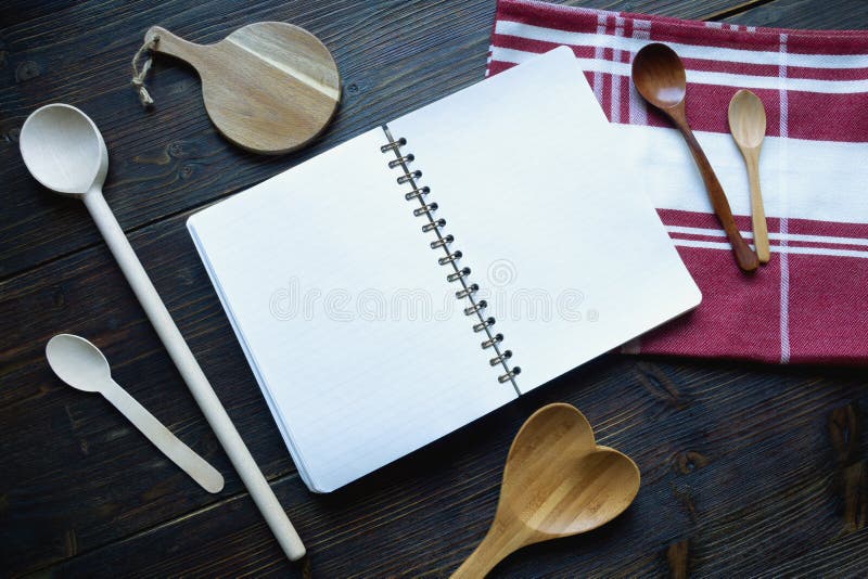 Recipe Book on Kitchen Table. Wooden Spoons and Cutting Board. Copy ...