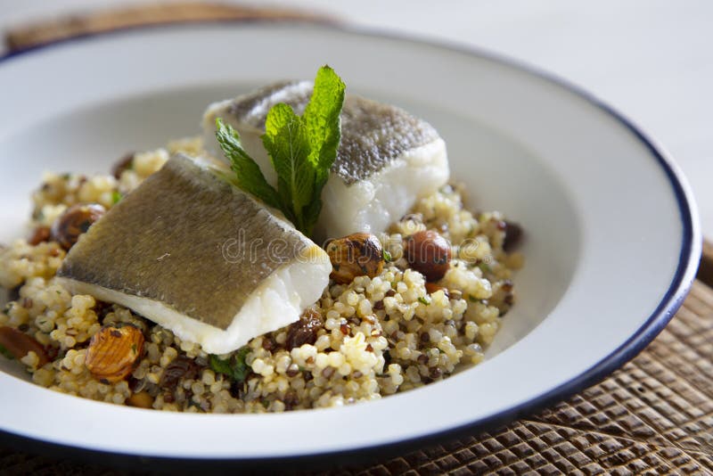 Cod Loins Cooked in the Oven with Quinoa and Peach. Stock Image - Image ...