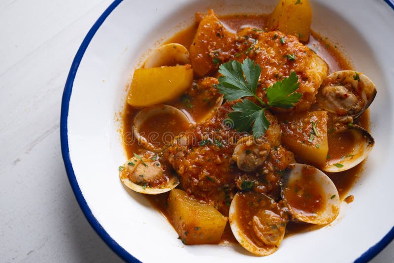 Cod Loins Cooked in the Oven with Tomato and Clams. Stock Image - Image ...