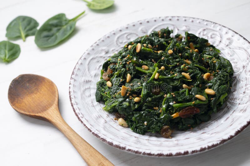 Spinach Cooked in a Pan with Raisins, Pine Nuts and Garlic. Stock Image ...