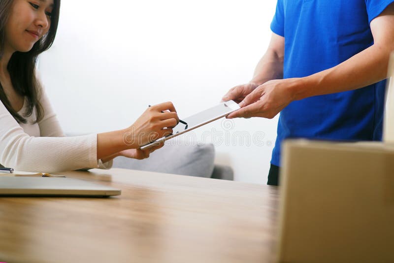 The Recipient Signs the Receipt for the Package. Fast Box Delivery ...