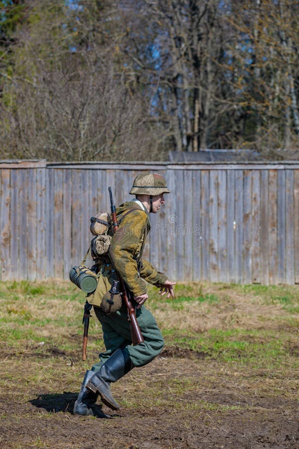 Reconstruction of the Second World War. a German Soldier is Running ...