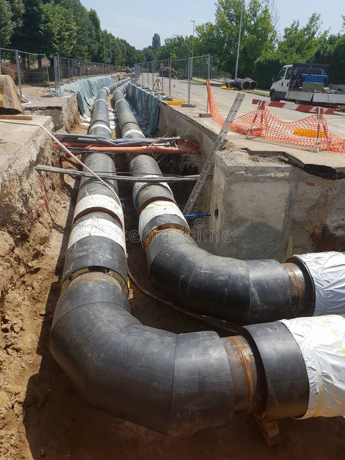 Laying Heating Pipes in a Trench at Construction Site Stock Image ...