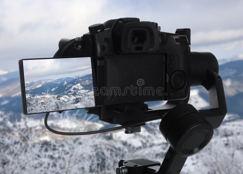 Recording Beautiful View of Snowy Mountains on Video Camera Stock Photo ...