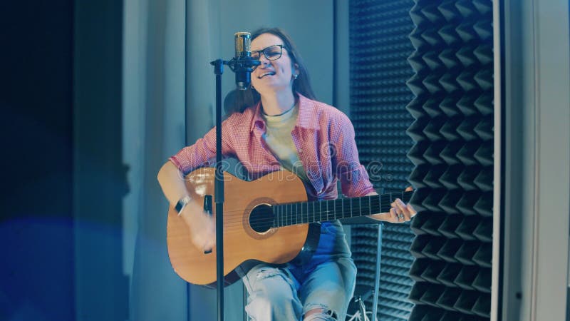 Recording Booth with a Woman Singing and Playing the Guitar Stock Video ...