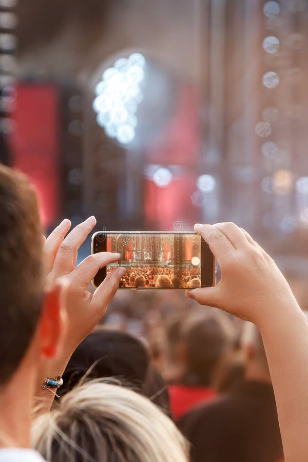 Recording a Concert Using a Mobile Phone. Smartphone at Music Show ...