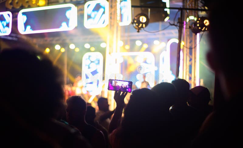 Recording the Musical Show from the Lifted Mobile Phone in the Crowd ...
