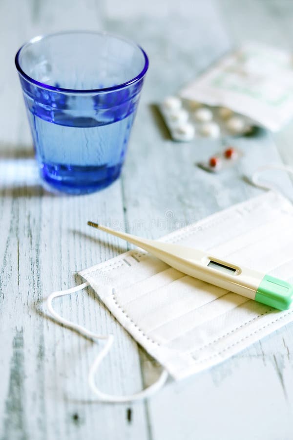 Recovery at Home, a Surgical Mask, a Thermometer, and Tablets Stock ...