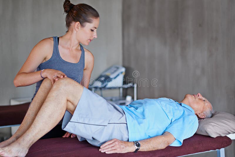 Recovery is a Long Process. an Elderly Man Having a Physiotherapy ...