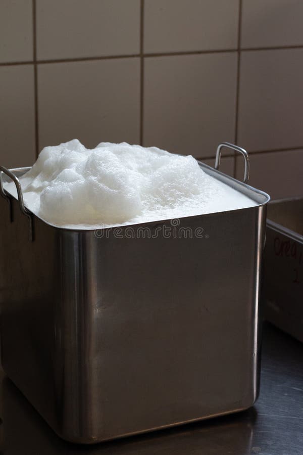 A Rectangle Metal Container Ed with Fresh Milk Foam in an Industrial ...
