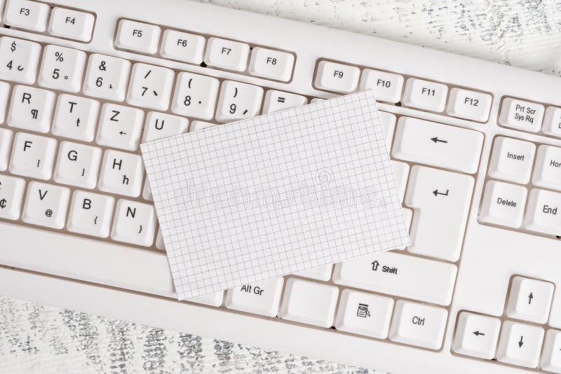 Rectangle Shaped Note Colored Paper in a Keyboard and a White Wooden ...