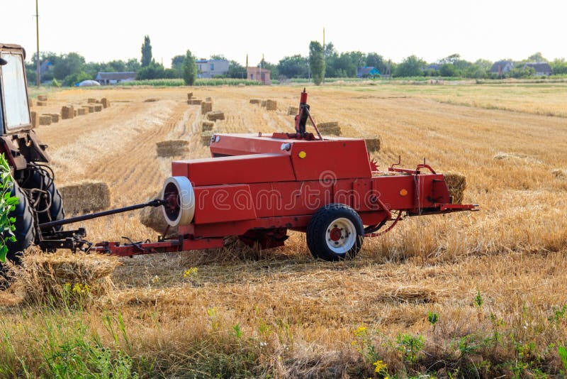 Rectangular Baler Discharges Straw Bale in a Field during the ...