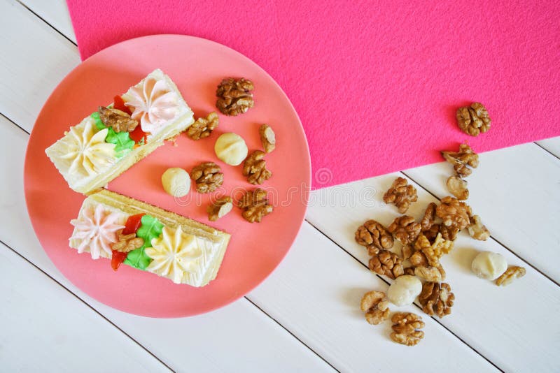 Rectangular Biscuit Cake with Cream Flowers and Peeled Nuts in a Plate ...