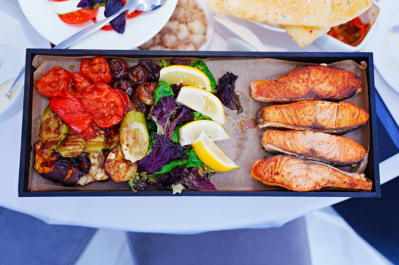 Rectangular Black Dish with Grilled Fish and Vegetables. Stock Photo ...