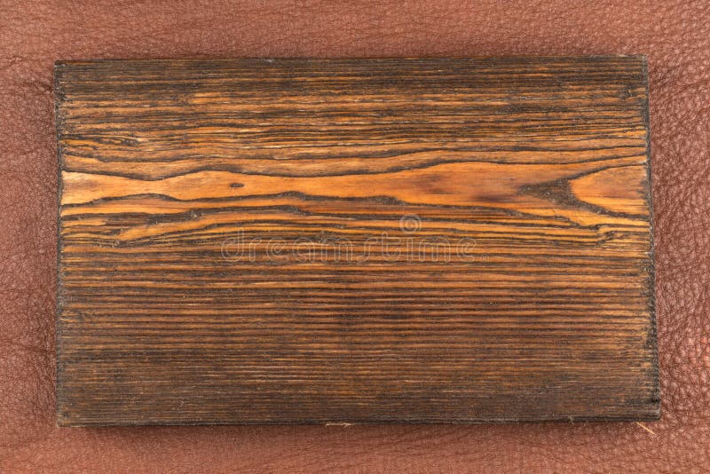 Rectangular Board of Light Wood Lies on Brown Natural Leather. Texture ...
