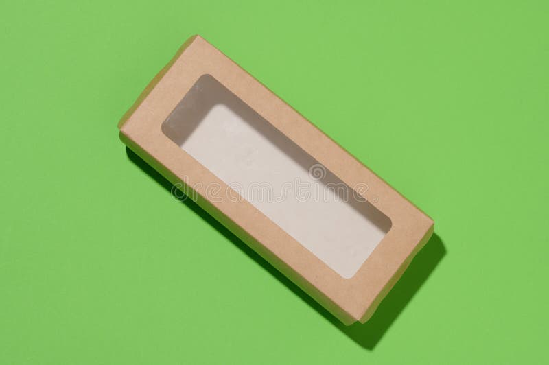 Rectangular Cardboard Box with a Transparent Plastic Lid on a Green ...