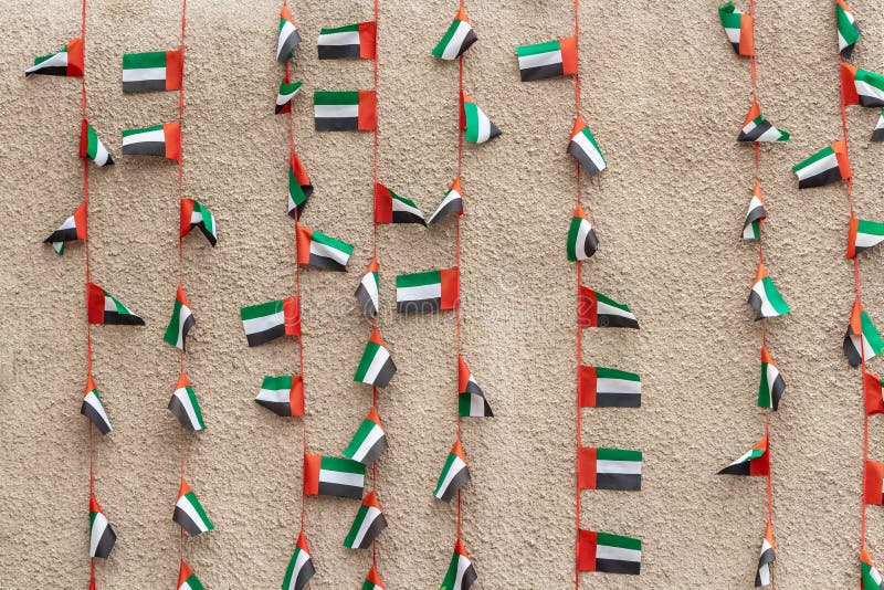 Rectangular Colored Flags Hang on a Red Rope on the Yellow Wall ...