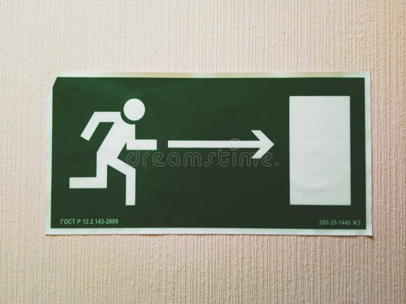 Rectangular Green Emergency Exit Sign on the Wall. Stock Photo - Image ...