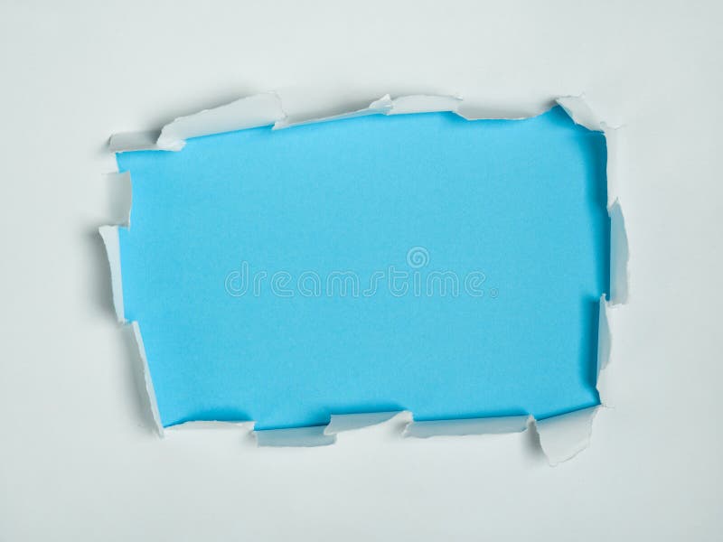 A Rectangular Hole Ripped in White Paper Reveals a Bright Blue ...