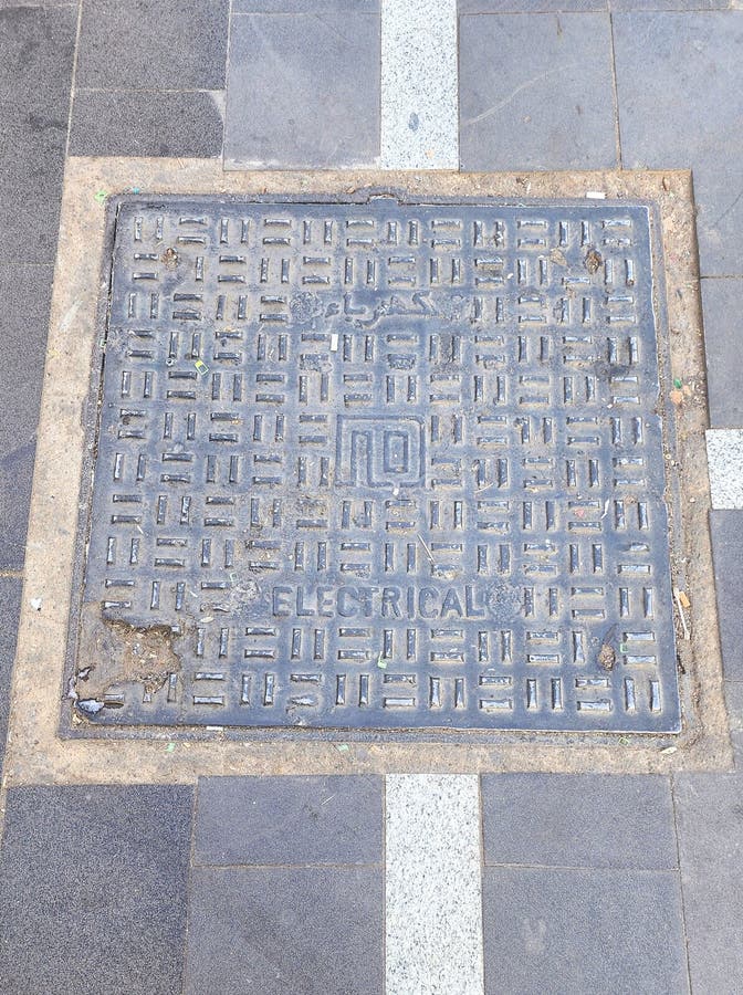 A Rectangular Metal Manhole Cover Embedded in a Paved Sidewalk Stock ...