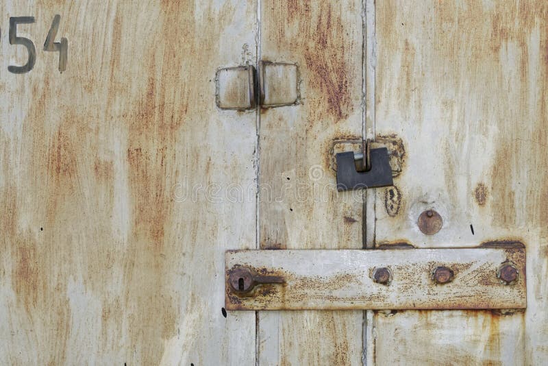 A Rectangular Padlock Hangs from the Old Rusty Metal Doors of an ...