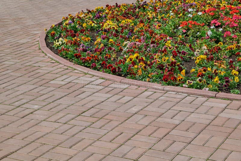 A Path of Paving Stones Around a Round Flower Bed Stock Image - Image ...