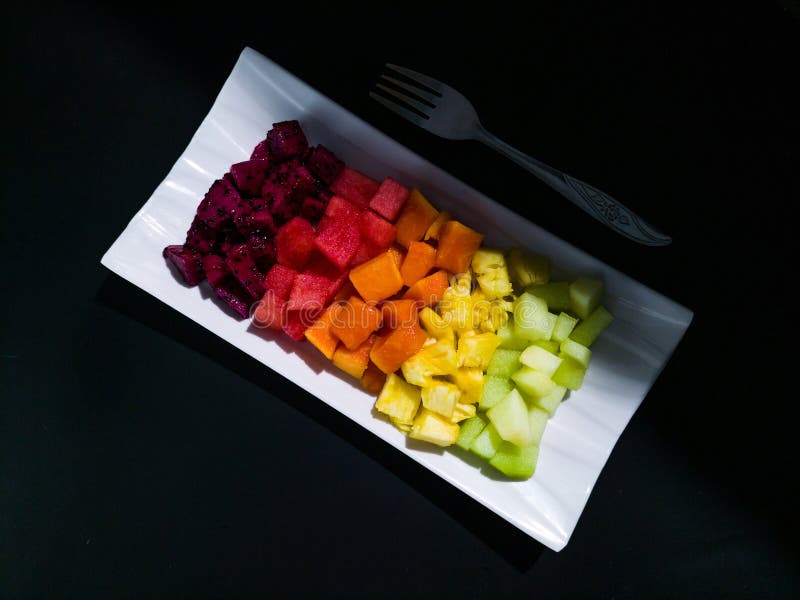 Rectangular Plate with Fruits Salad on Black Background Stock Photo ...