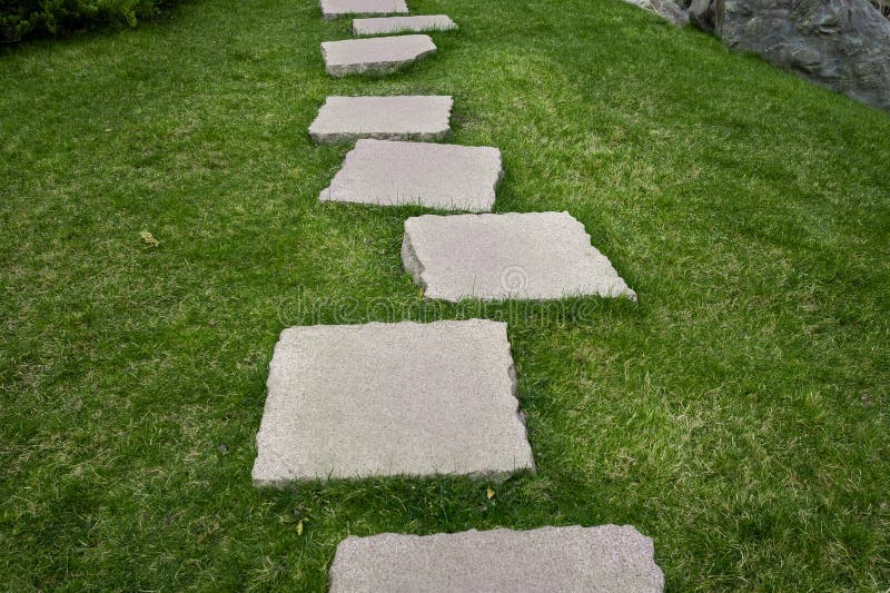 Rectangular Stone Tiles Form Stepping Path Across the Grass. Suitable ...