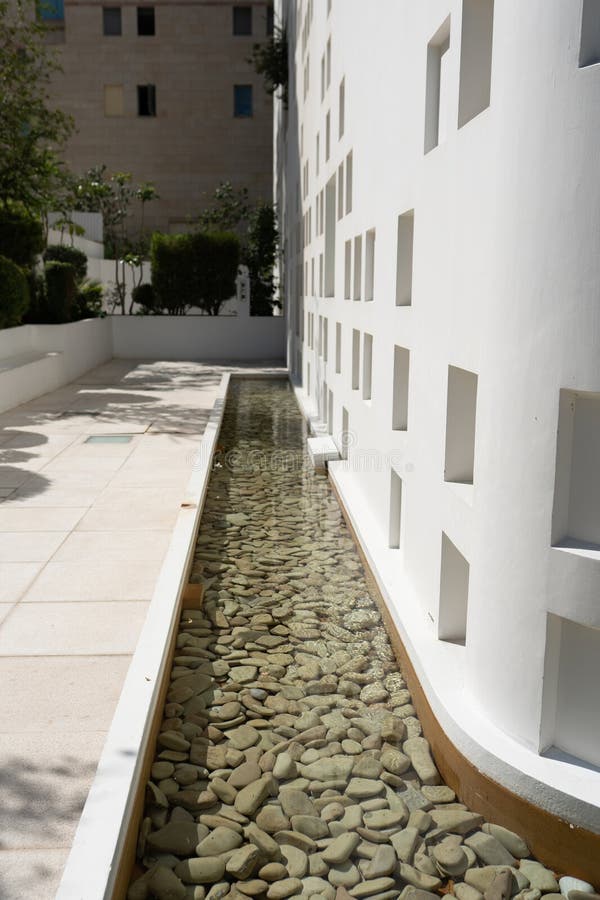 Rectangular Water Feature Filled with Smooth Stones, Reflecting a ...
