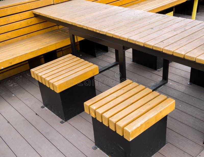 Rectangular Wooden Table and Square Ottoman Seats Stock Photo - Image ...