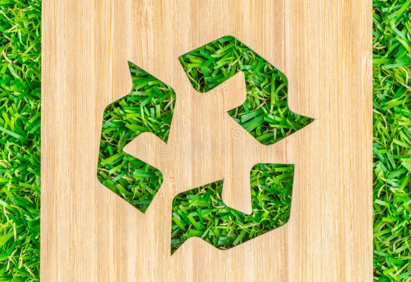 Recycle Sign Cut in the Wooden Board on Grass Stock Photo - Image of ...
