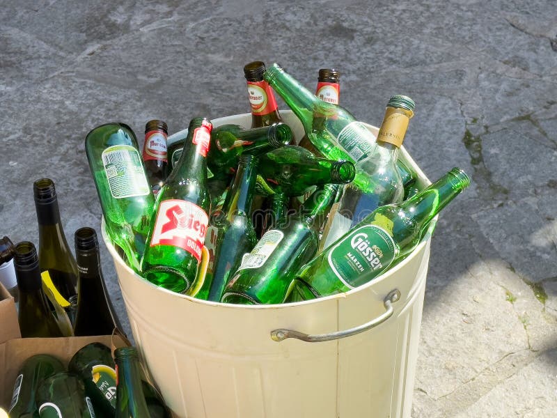 Recycling Bin Overflowing with Empty Green Glass Bottles on Pavement ...