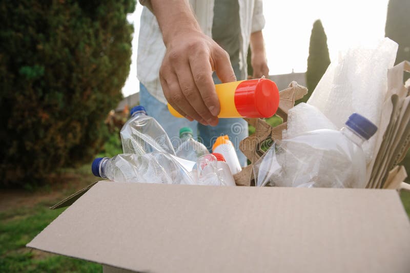 Recycling Concept. Man Putting Plastic Bottle into Cardboard Box ...