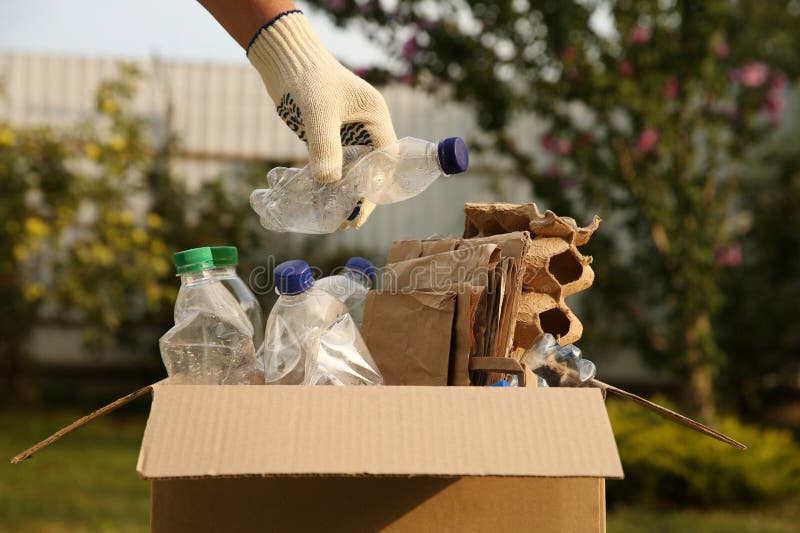 Recycling Concept. Man Putting Plastic Bottle into Cardboard Box ...