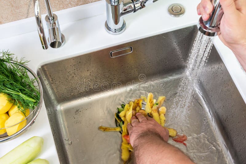 Recycling Food Waste with a Disposer in the Kitchen Sink Stock Image ...