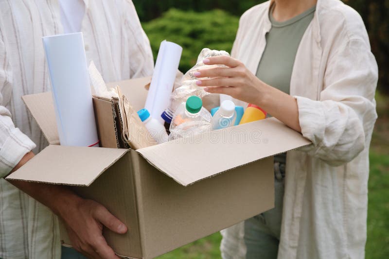 Recycling. People with Cardboard Box Full of Different Garbage Outdoors ...