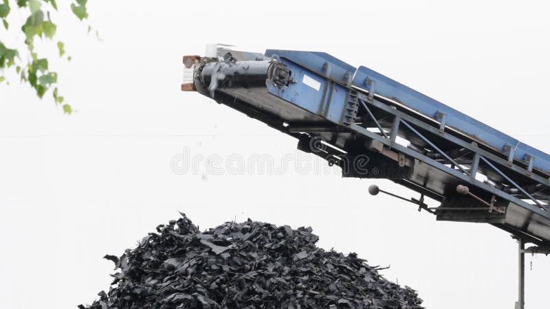Recycling and Processing of Old Tires, Crushed Rubber Go on a Conveyor ...